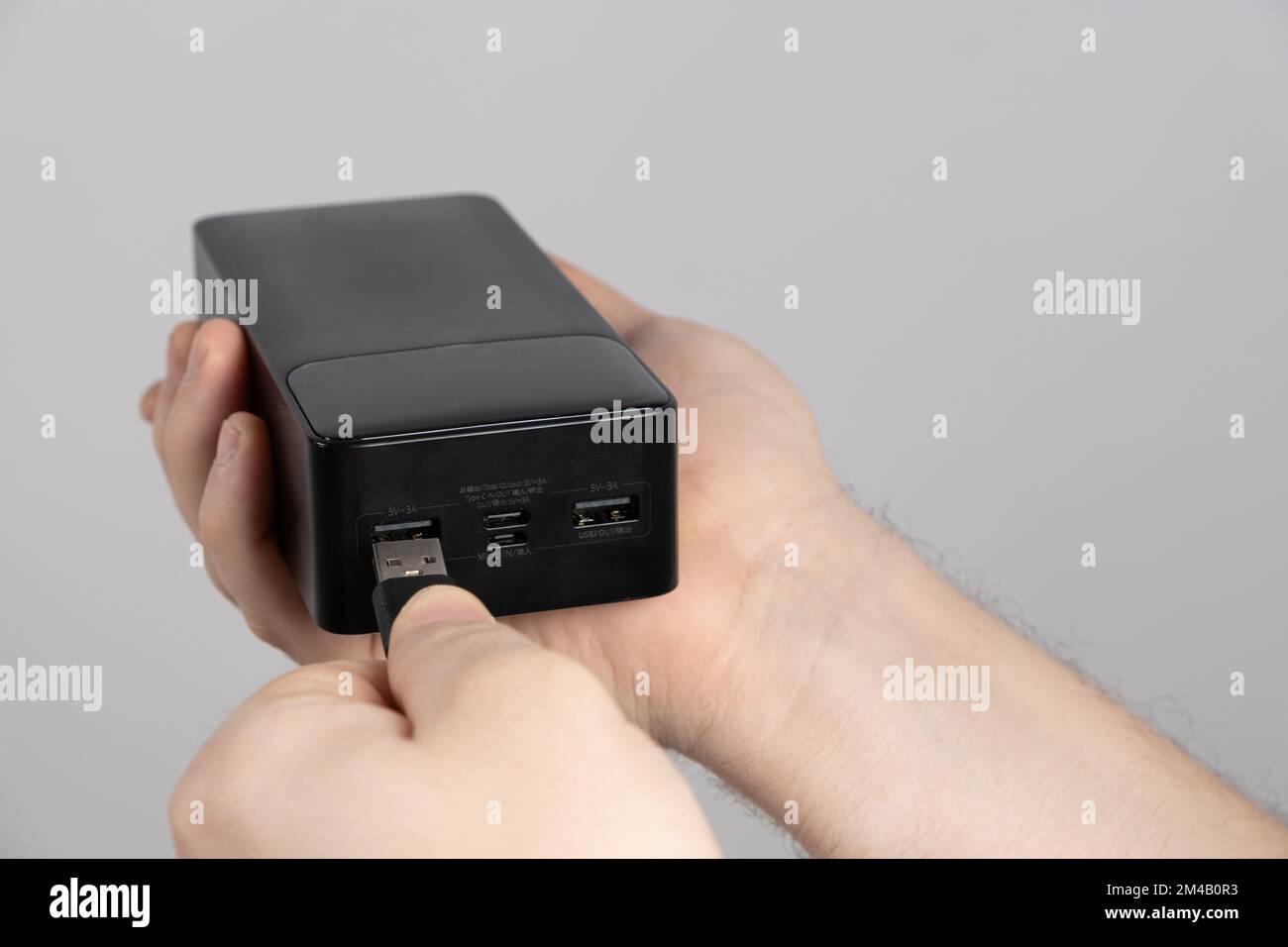 Connecting the cord to the power bank. Charging gadgets from the power ...