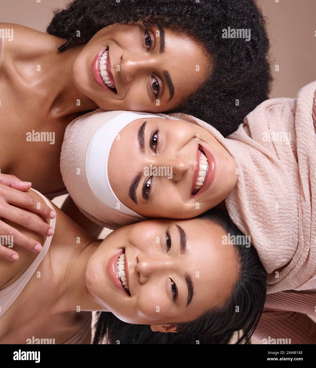 Face portrait, beauty and diversity of women in studio on a brown ...