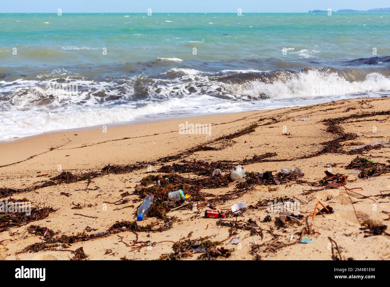 Garbage sea sand beach, unsorted rubbish, plastic bag, glass bottle ...