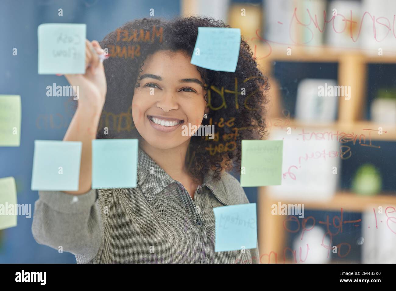 Glass, sticky notes and woman writing idea, planning and strategy in ...