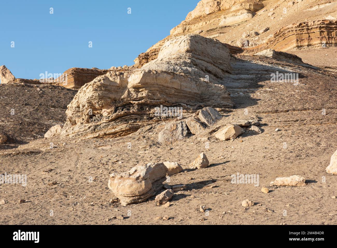 Rocky slope landscape in an arid desert environment with large pyramid ...