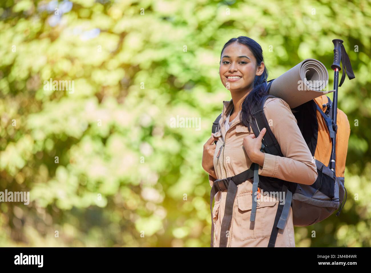 Hiking, portrait and fit woman backpacking in nature for fitness ...