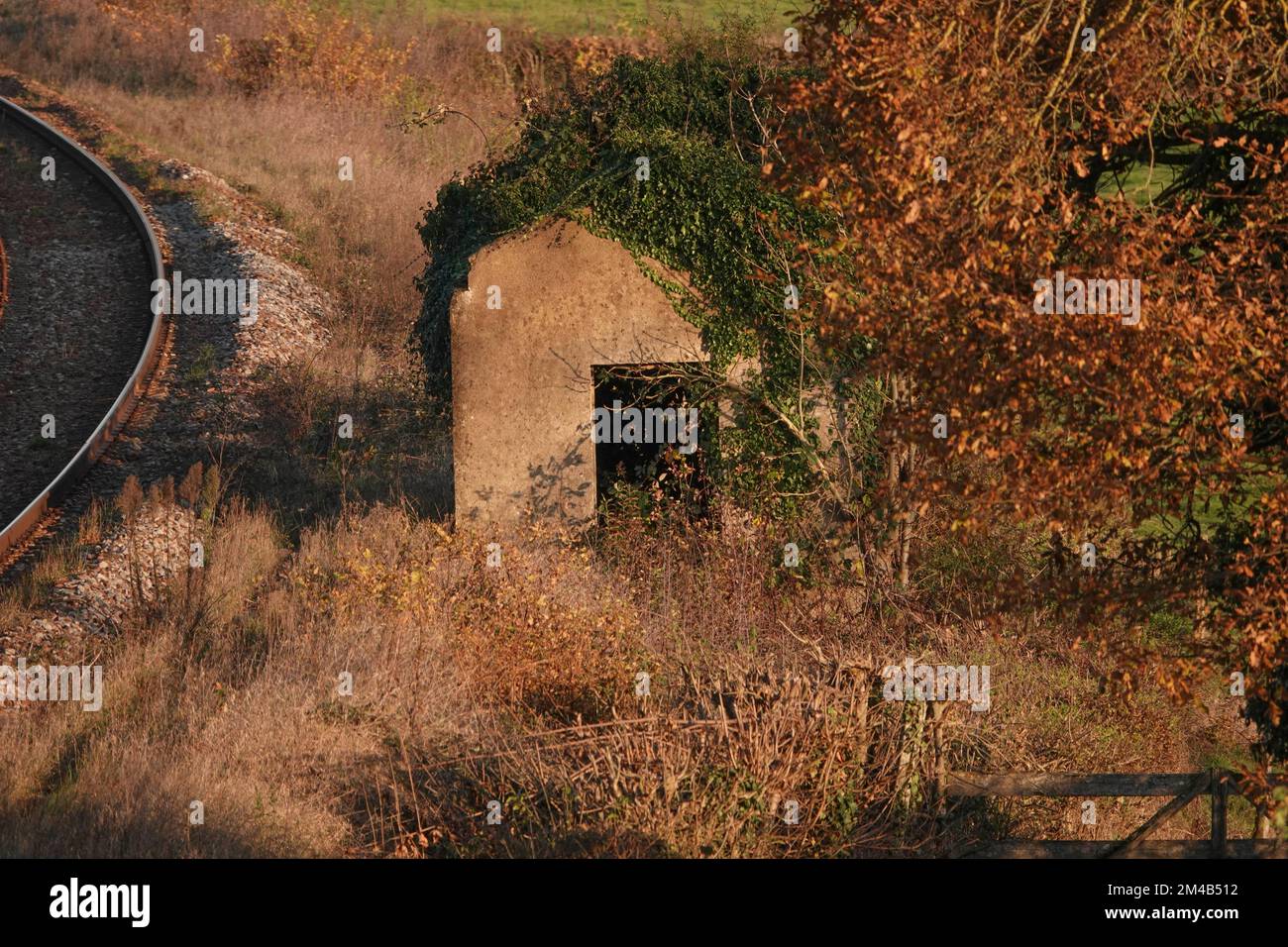 An abandoned destroyed concrete hut by the train rails in Autumn Stock ...
