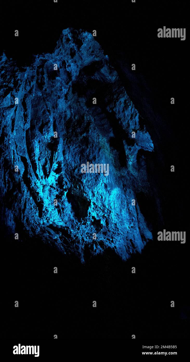 The inside of a cave lit up in blue light Stock Photo - Alamy