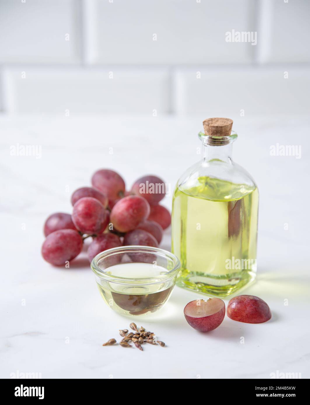 Natural vegetable oil from grape seeds in a clear bottle on the kitchen ...