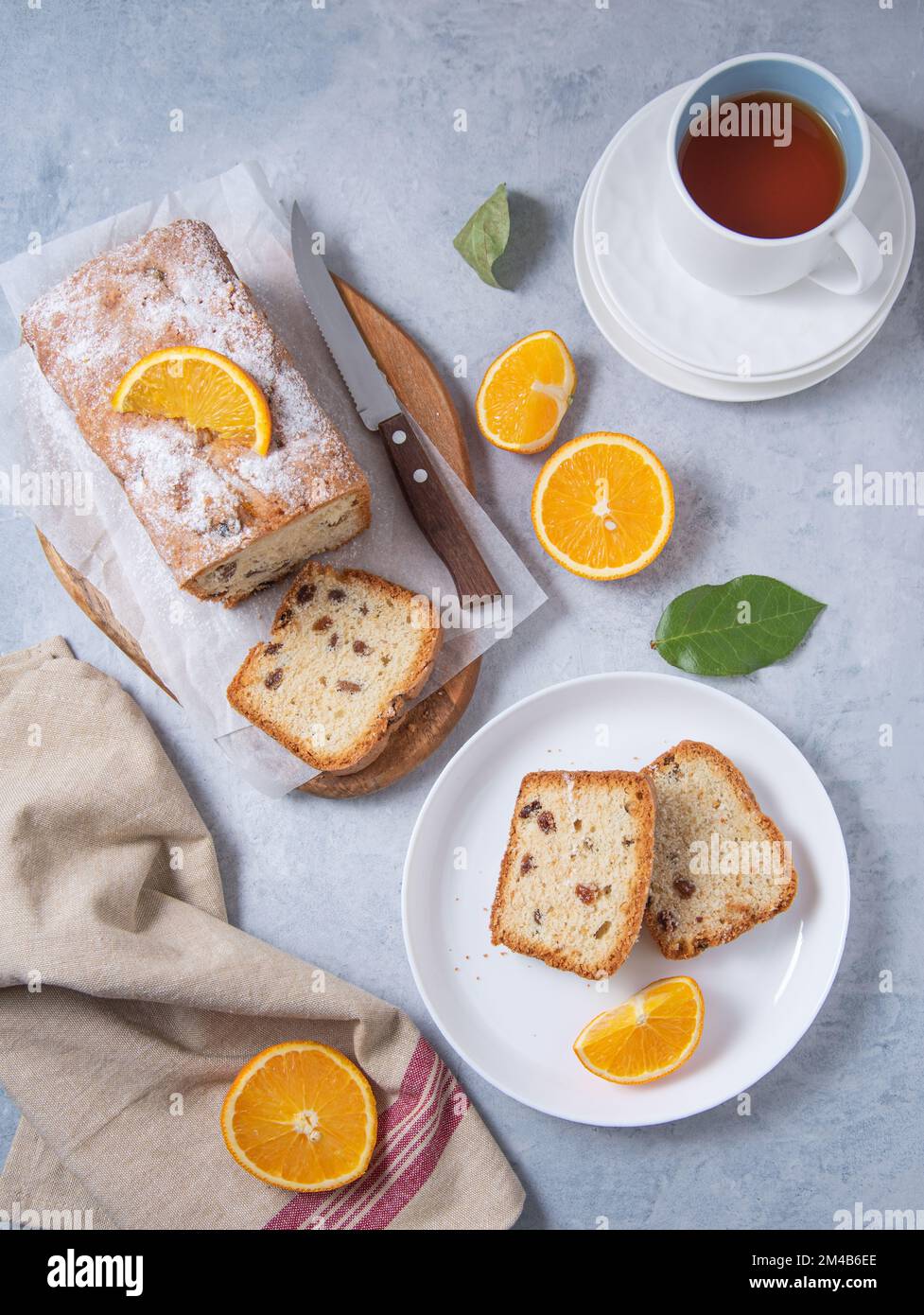 Concept breakfast. Freshly baked cake with raisins and orange on a ...