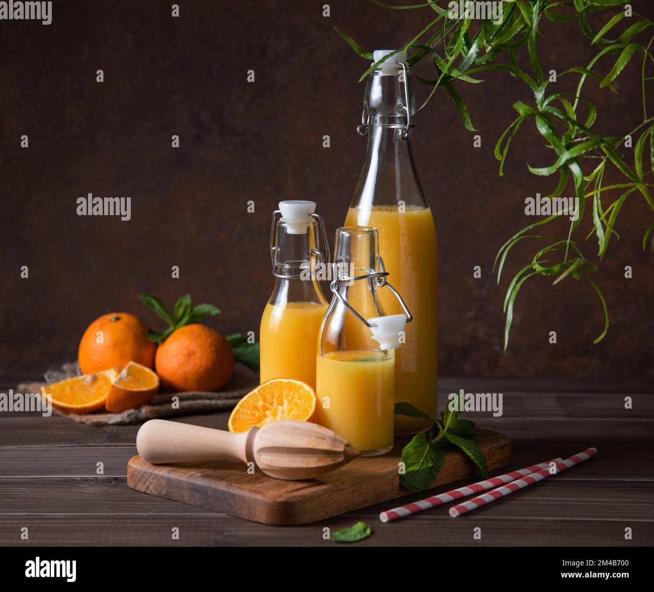 Healthy drink concept. Fresh orange juice in three bottles with citrus ...
