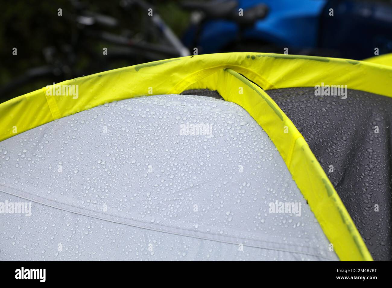 Tent top wet flysheet with raindrops. Intersecting tubes of the tent ...