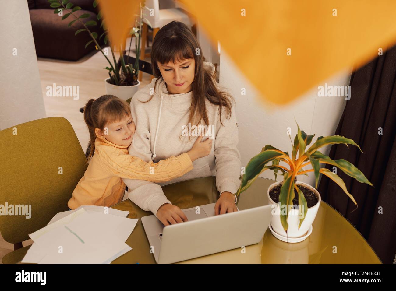 Working mom works from home office with kid. woman using laptop. Child ...