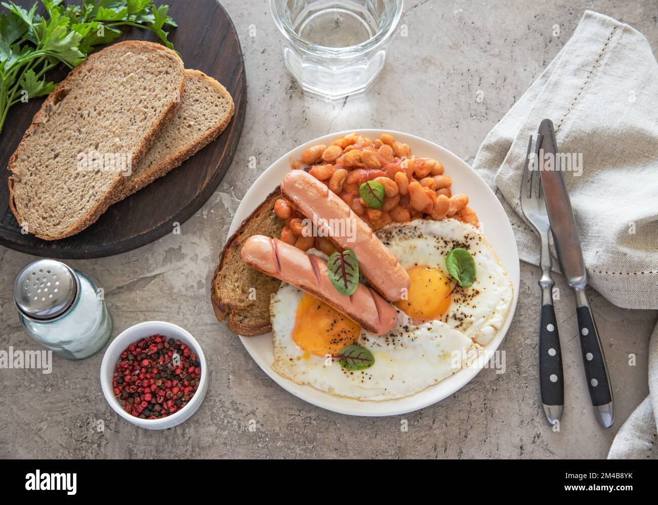 Traditional English breakfast with fried eggs, sausages, beans, fresh ...