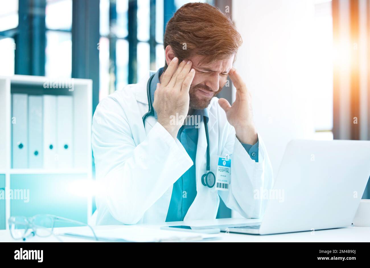 Doctor, headache and hospital computer of a healthcare man worker with ...
