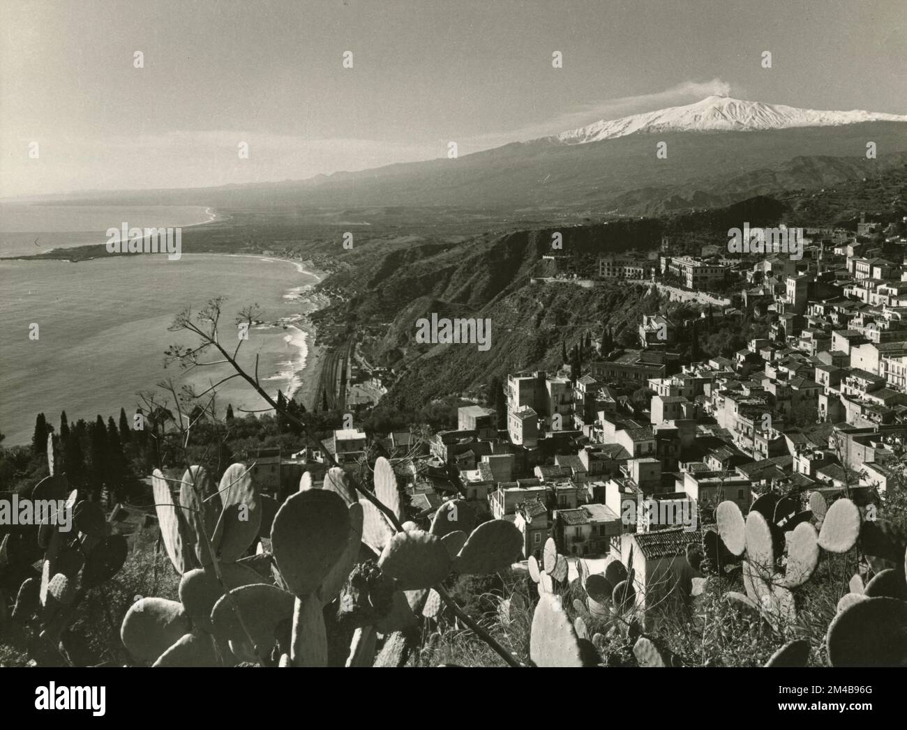 View of Taormina and Etna Volcano, Italy, 1950s Stock Photo - Alamy