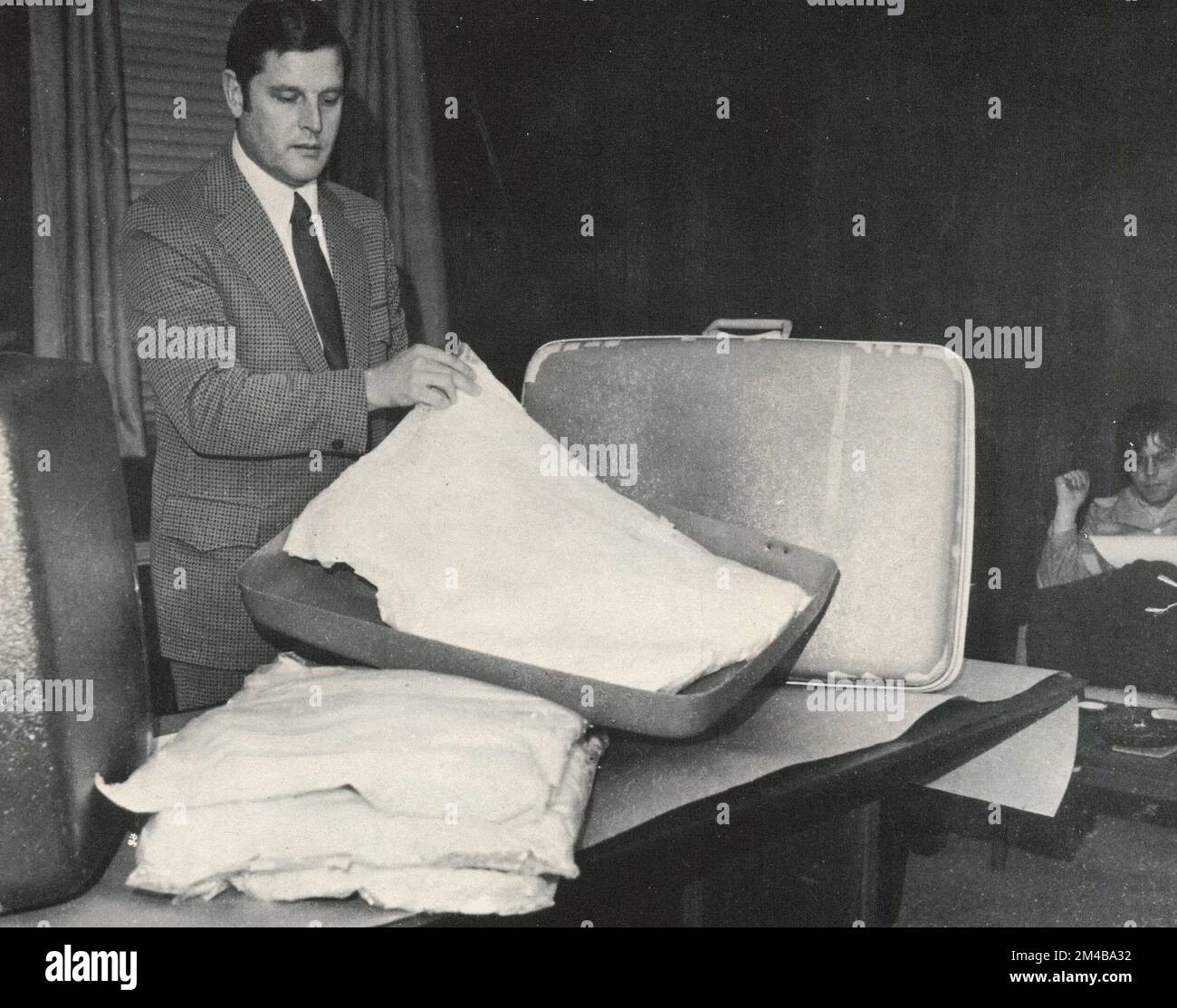 A Federal Bureau of Narcotics agent founding drug in the double bottom ...