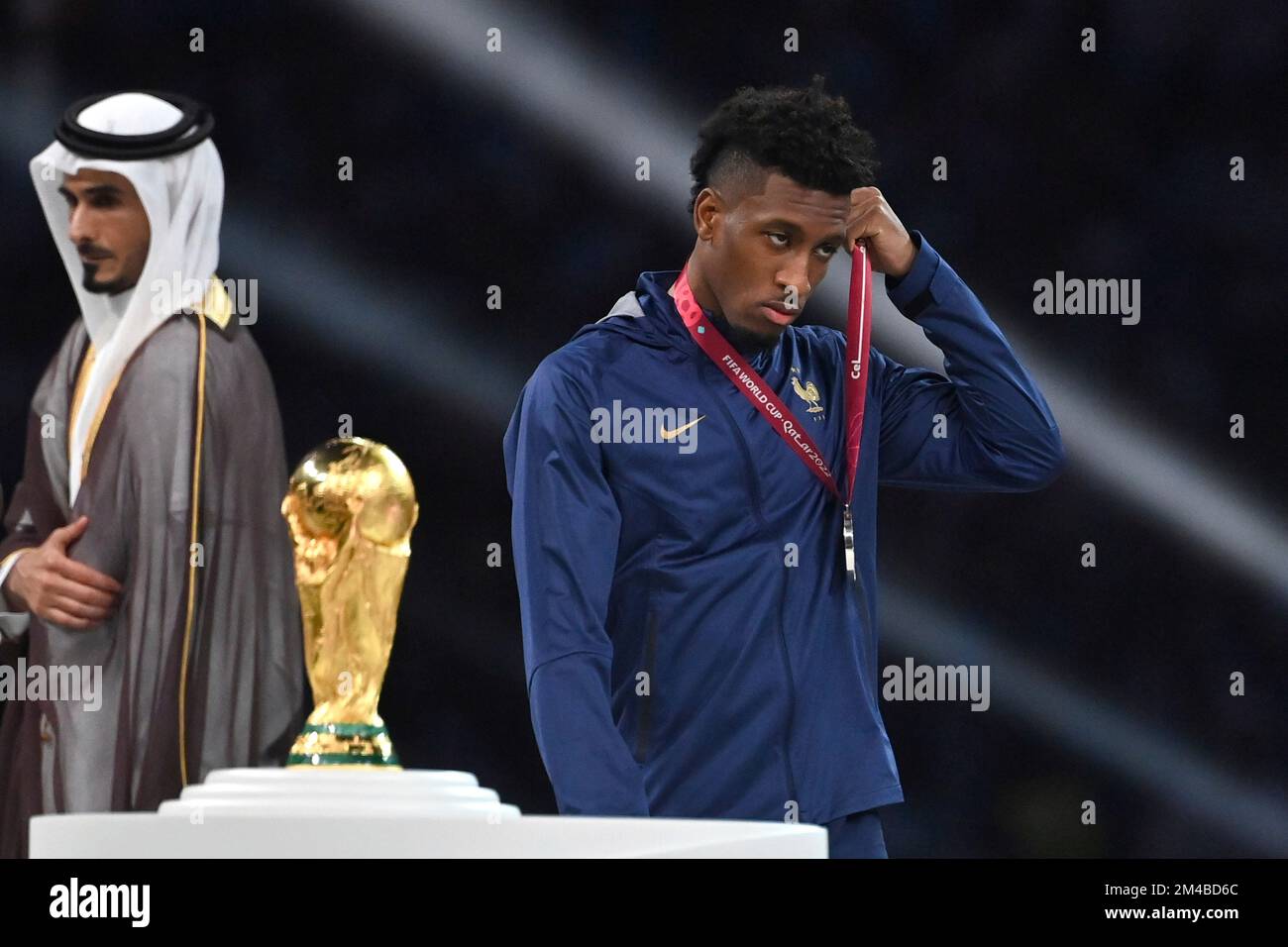 Award ceremony: Kingsley COMAN (FRA) walks past the trophy, cup, trophy ...