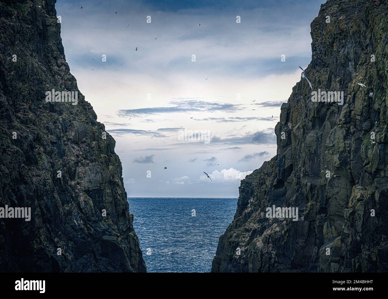 A beautiful shot of a seascape taken from in between two cliffs under ...