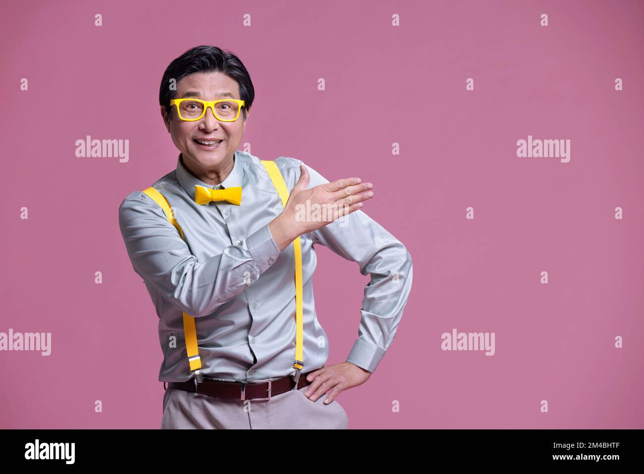 Studio shot of humorous senior Chinese man Stock Photo - Alamy