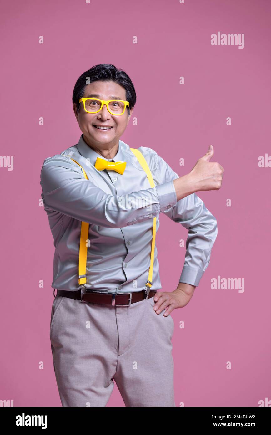 Studio shot of humorous senior Chinese man Stock Photo - Alamy