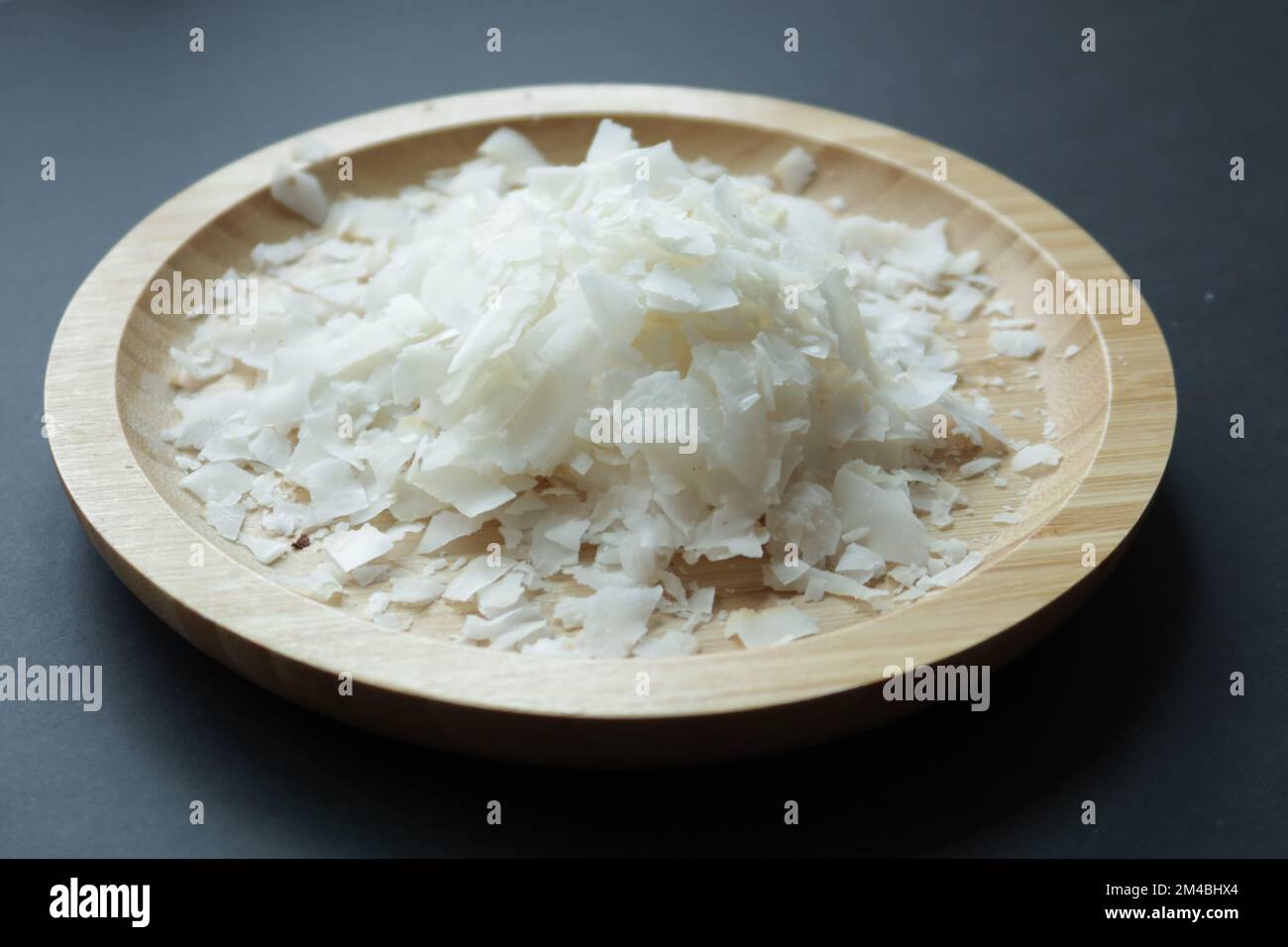 slice of fresh coconut flakes in a bowl on a table Stock Photo - Alamy