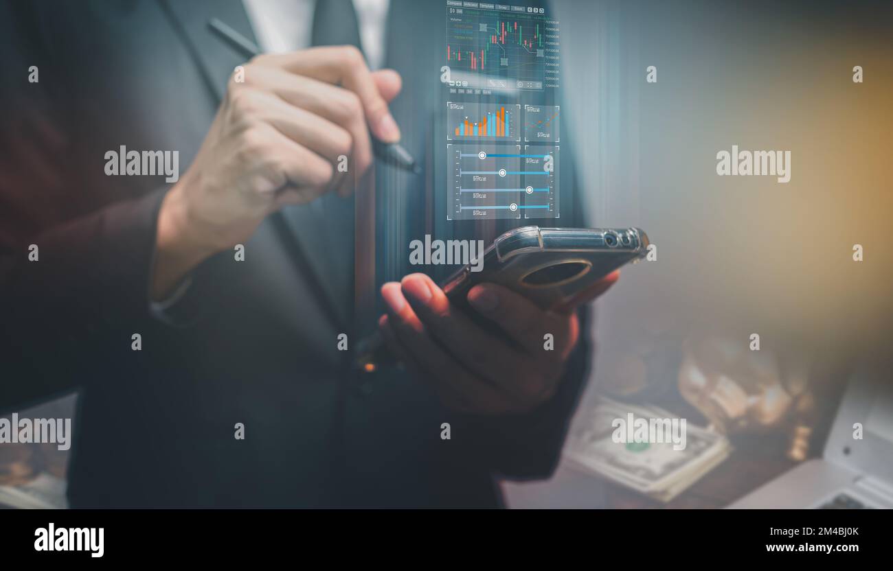 A Thai man using mobile phone with forex trading graph Stock Photo - Alamy
