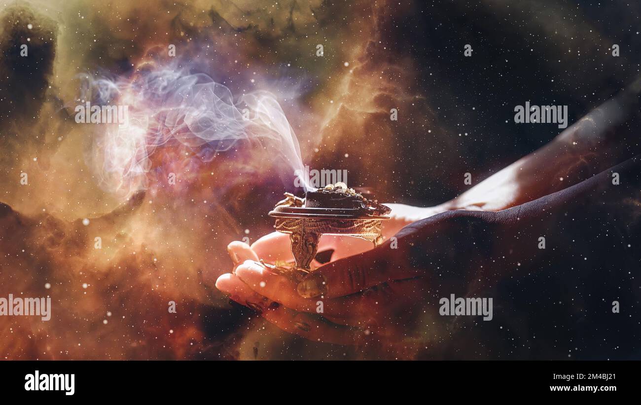 incense in a woman hand, incense smoke in cosmic space Stock Photo - Alamy