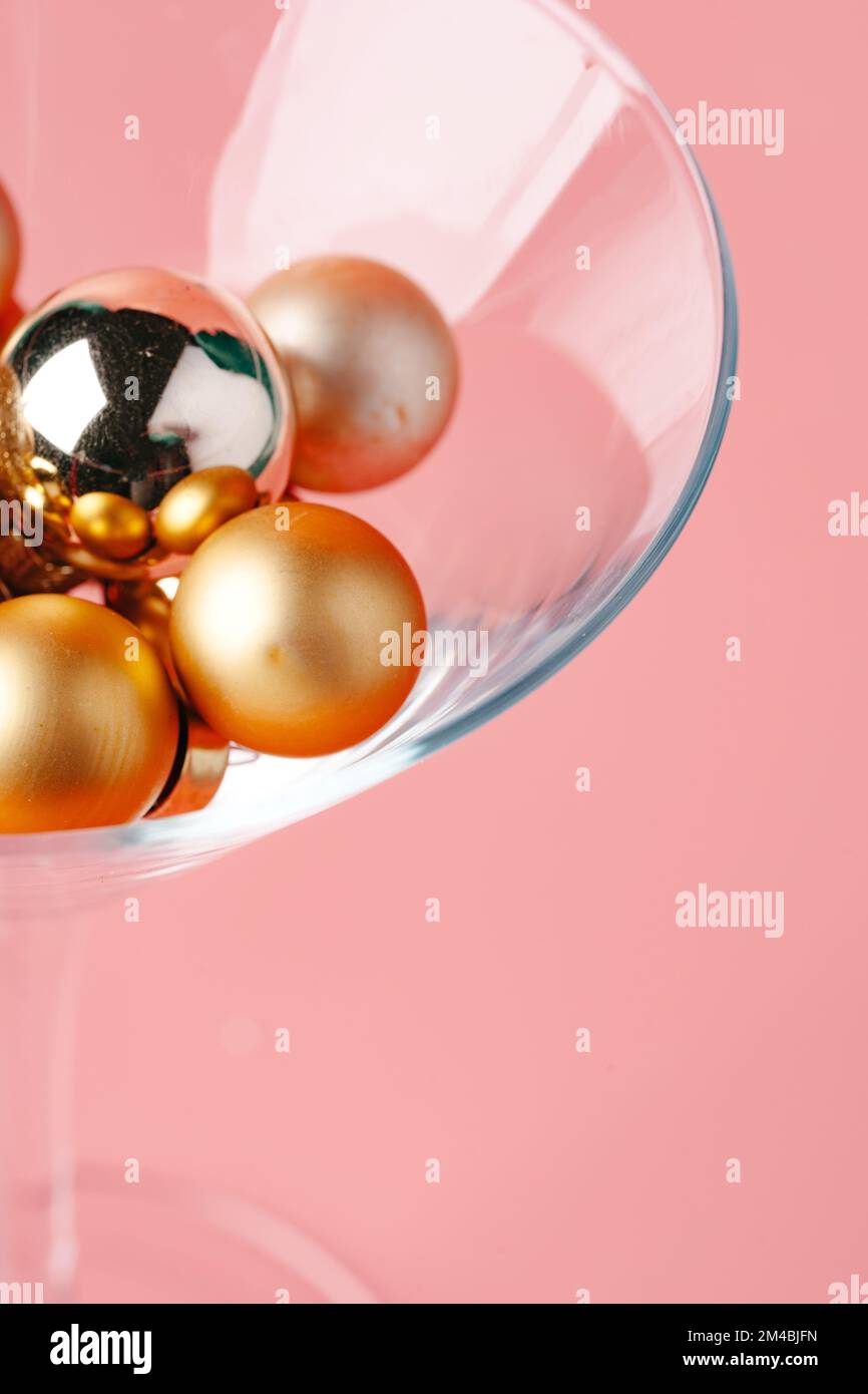 Glass with Christmas decorations on pink pastel background Stock Photo ...