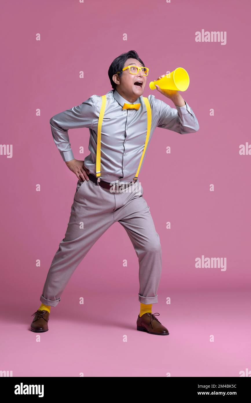 Senior Chinese man shouting through megaphone Stock Photo - Alamy
