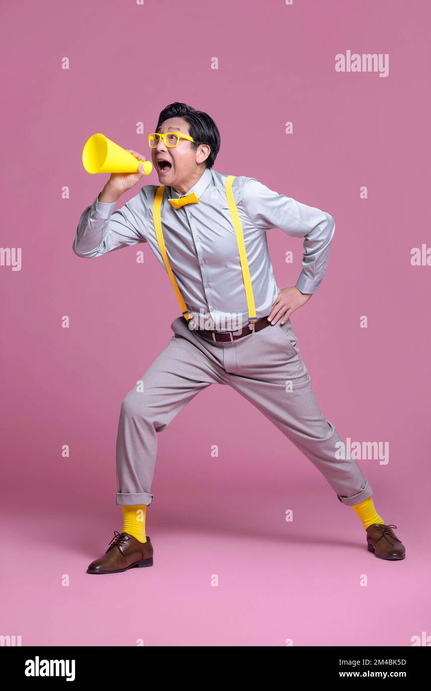 Senior Chinese man shouting through megaphone Stock Photo - Alamy