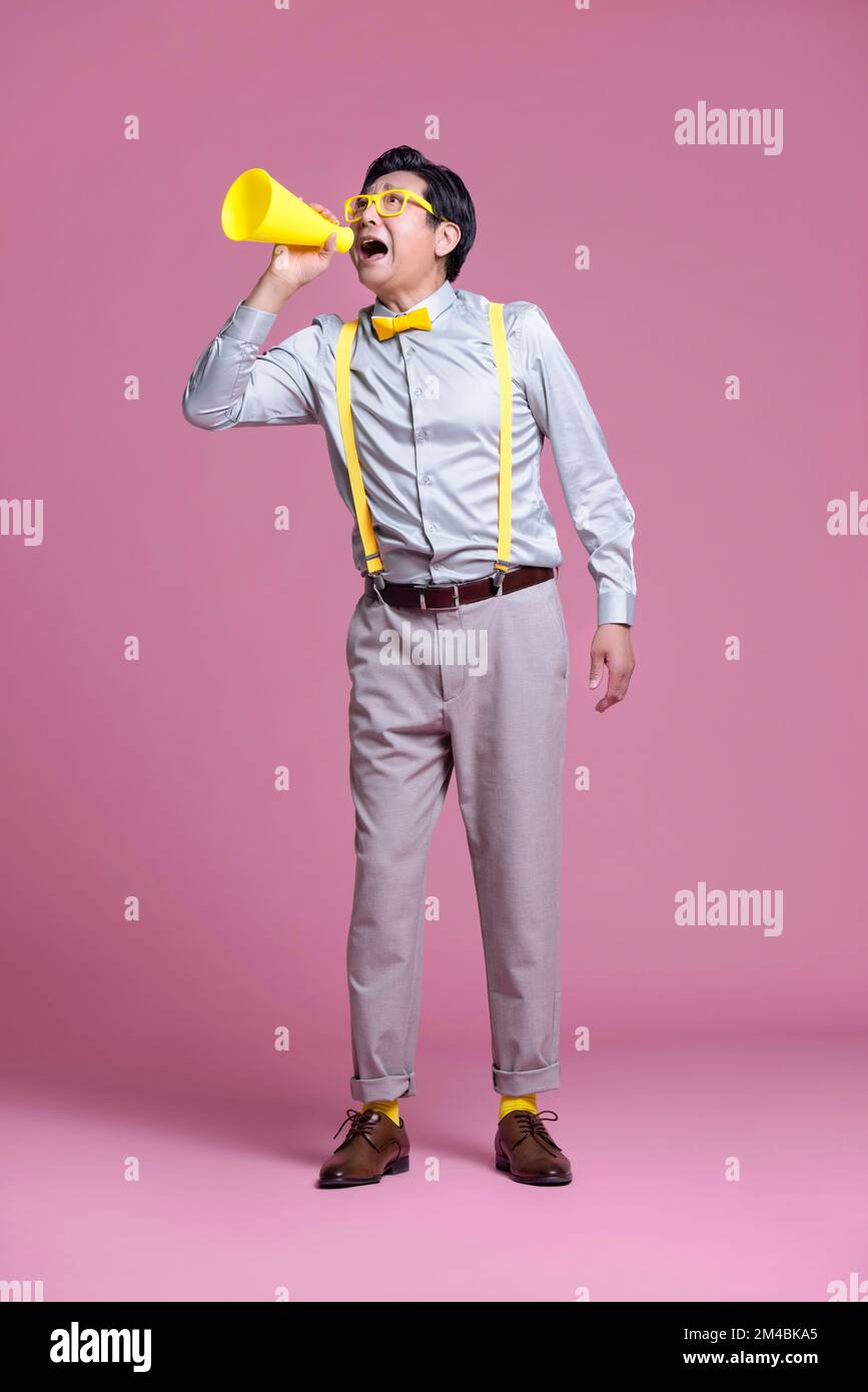 Senior Chinese man shouting through megaphone Stock Photo - Alamy