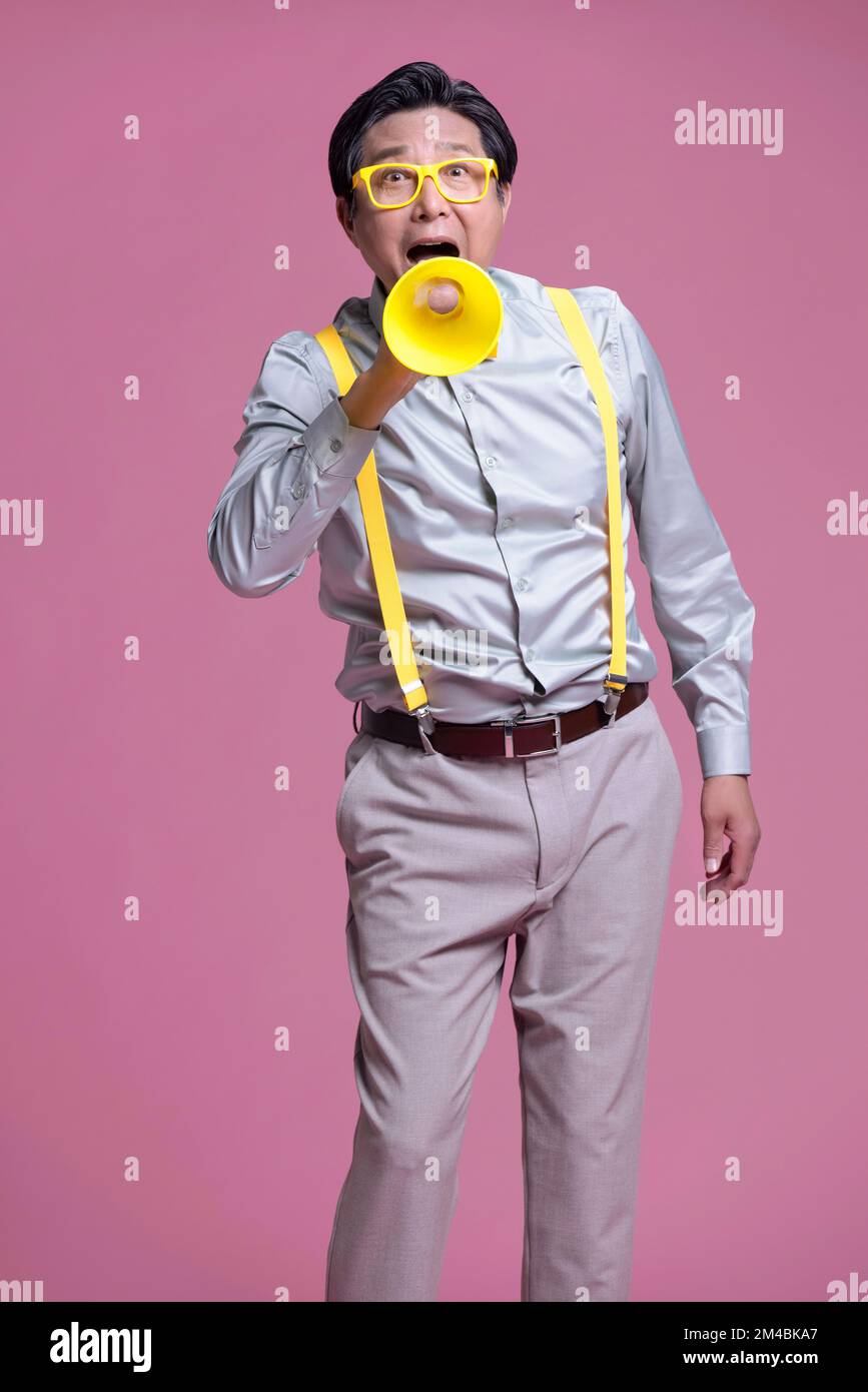 Senior Chinese man shouting through megaphone Stock Photo - Alamy