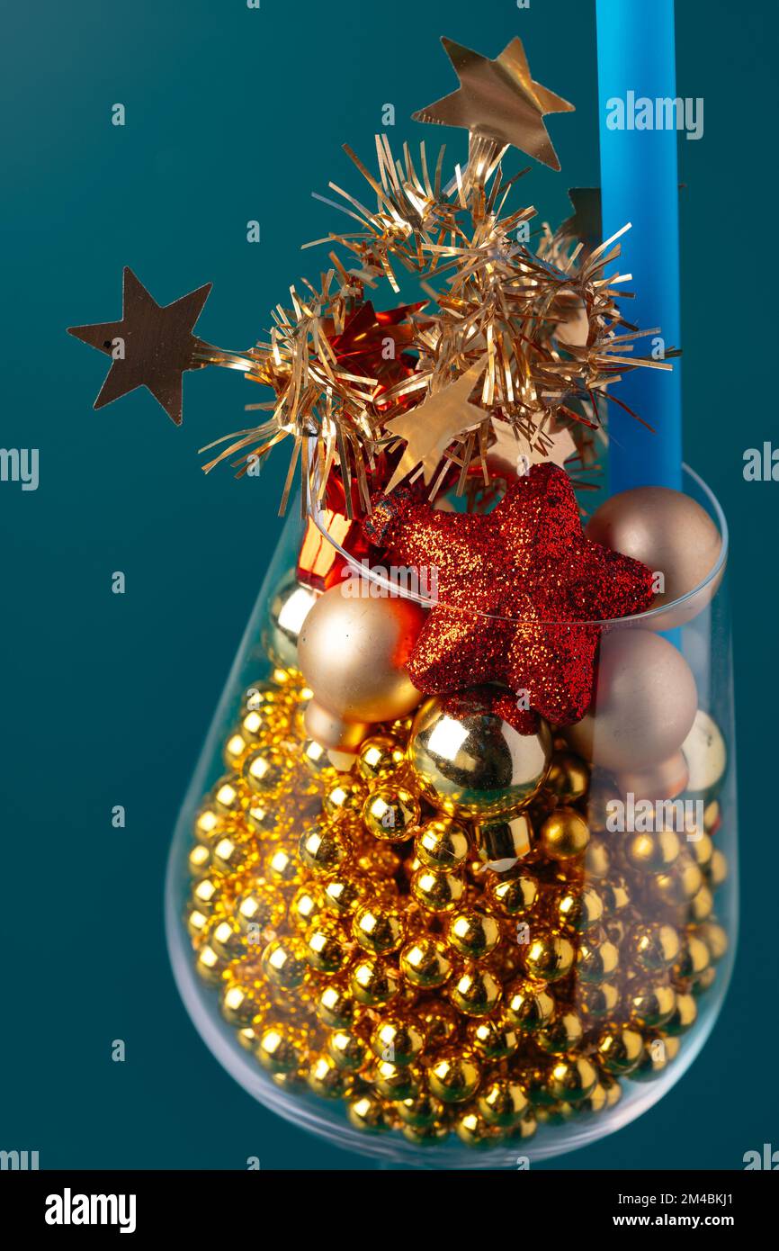 Glass with Christmas decorations on dark green background Stock Photo ...