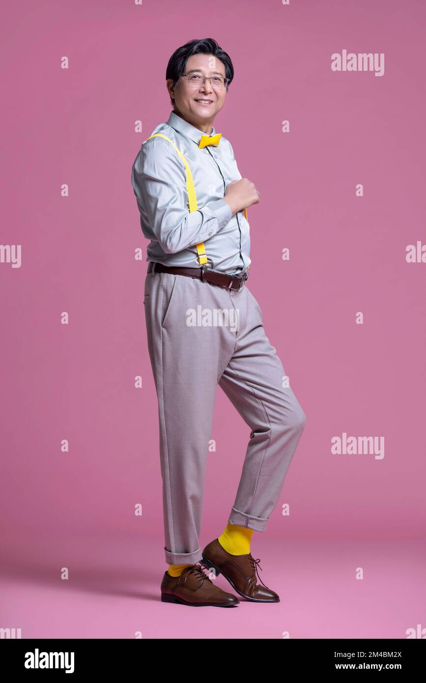 Studio shot of humorous senior Chinese man Stock Photo - Alamy