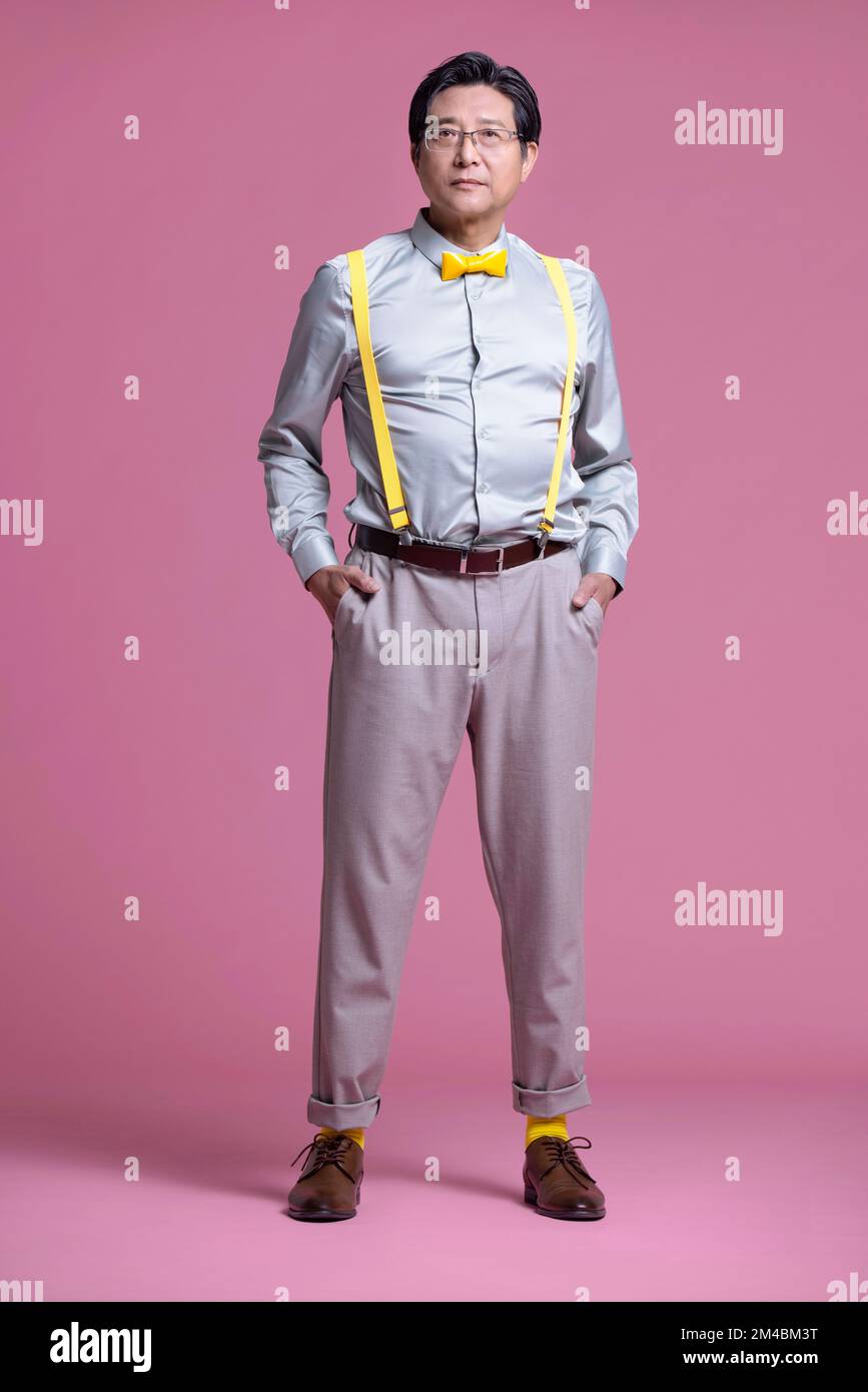 Studio shot of humorous senior Chinese man Stock Photo - Alamy