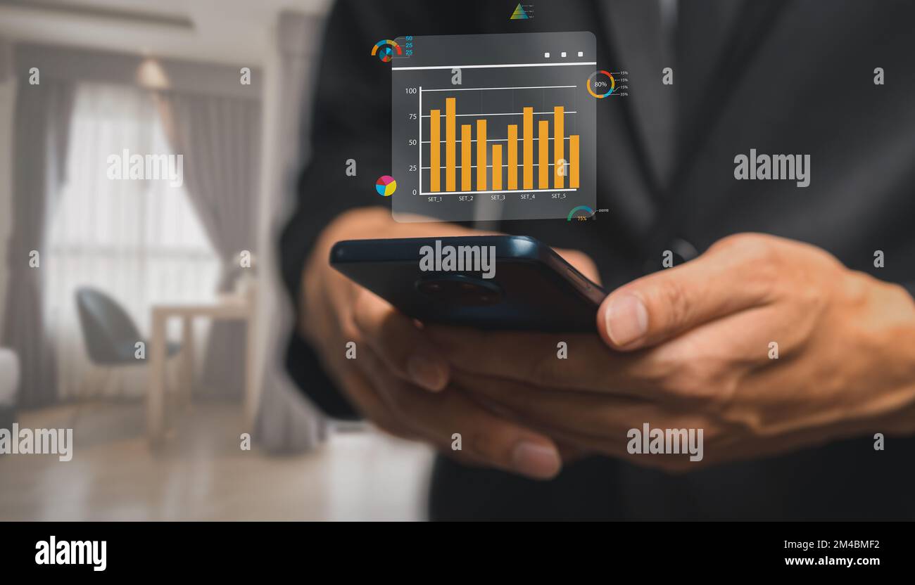 A businessman holding a tablet with forex trading graph-stock market ...