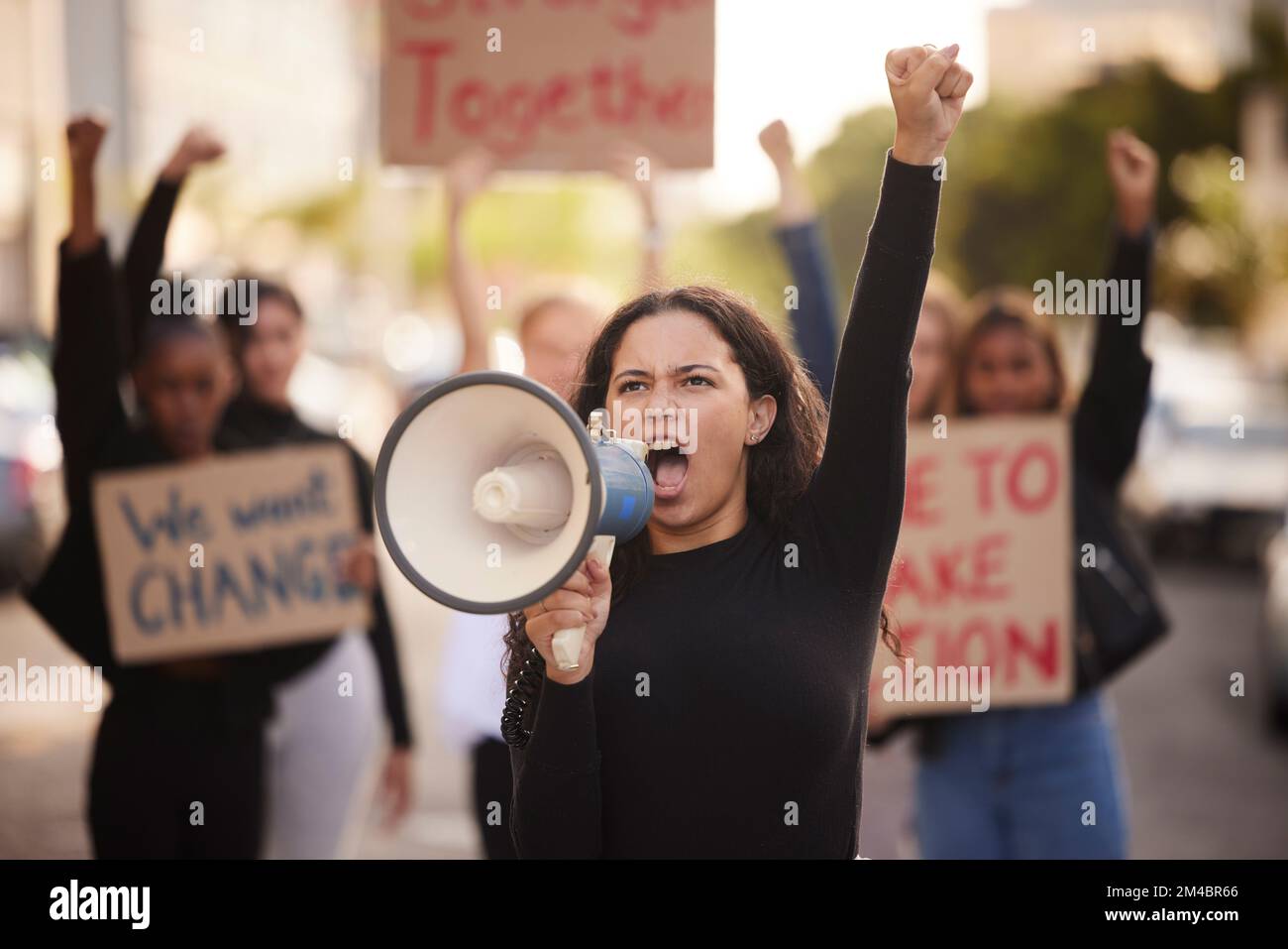 Woman, megaphone and fist in community protest for change, gender based ...