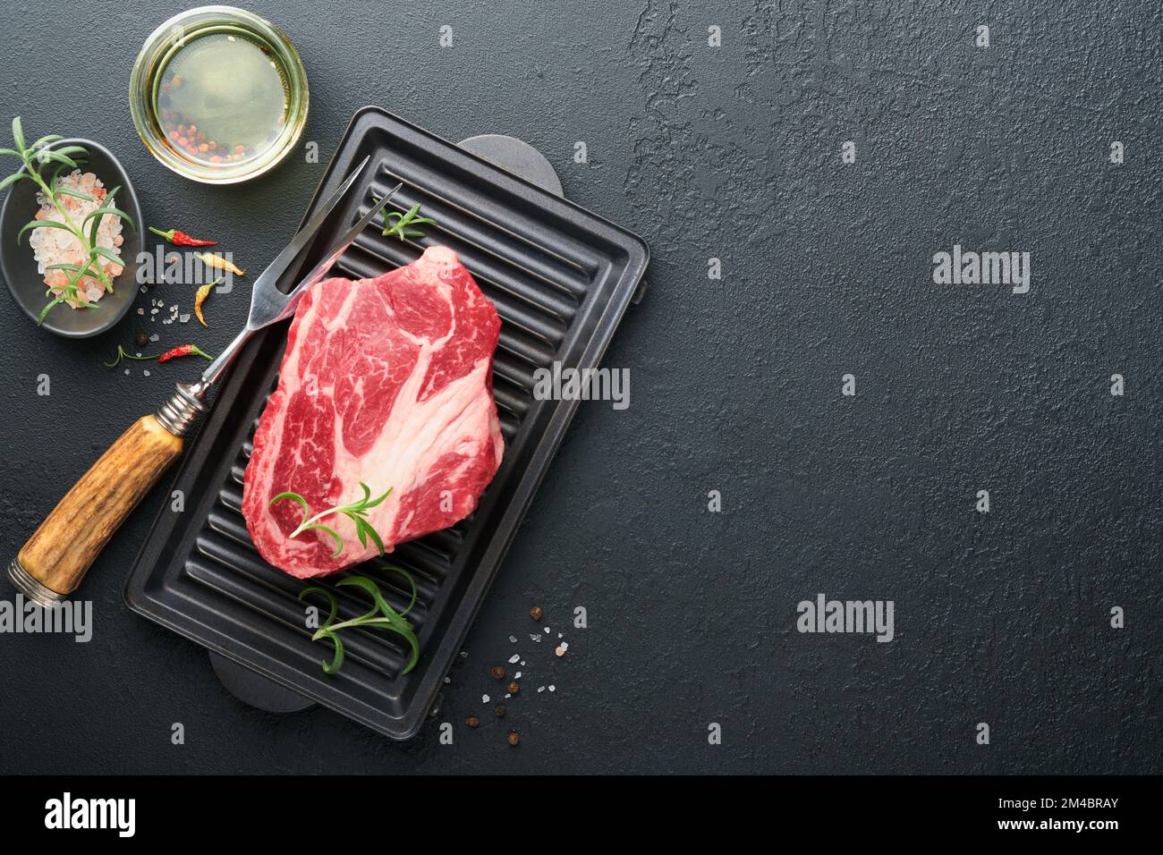 Raw beef steak. Raw fresh Chuck roll steak with rosemary, salt and ...