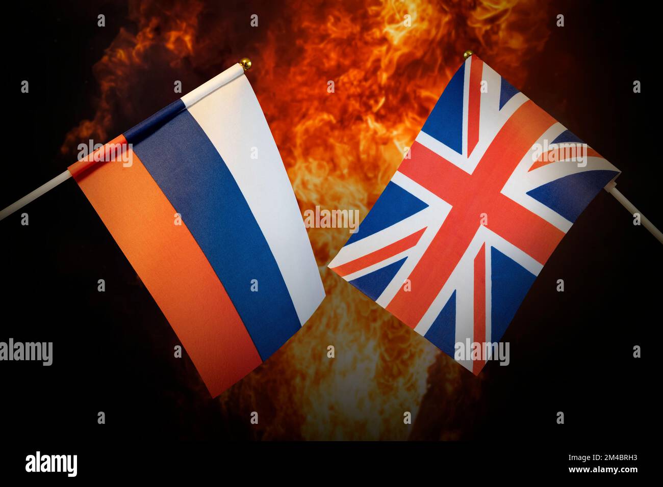 Flags of Russia and great britain against the background of a fiery ...