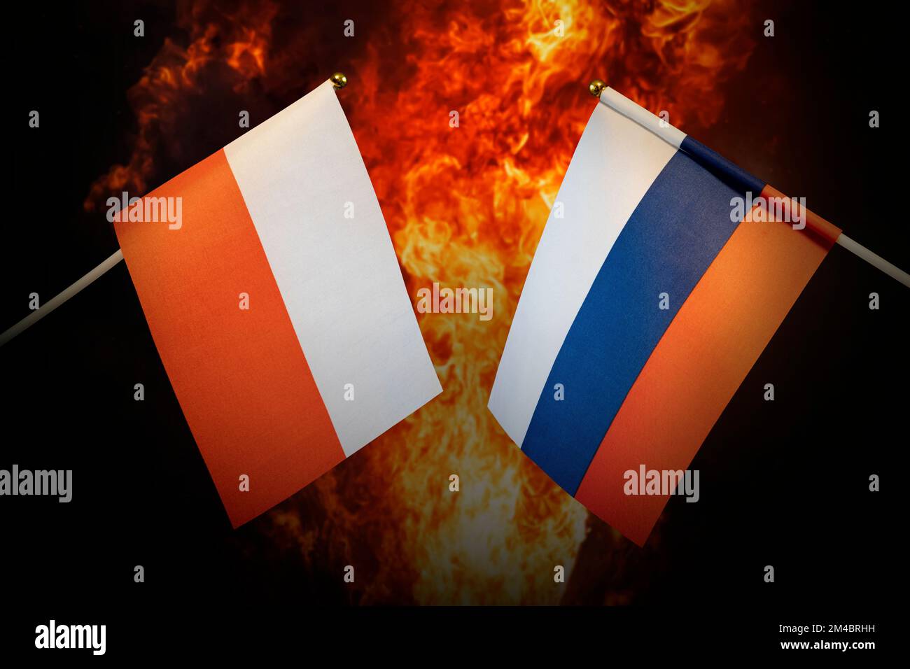 Flags of Russia and Poland against the background of a fiery explosion ...