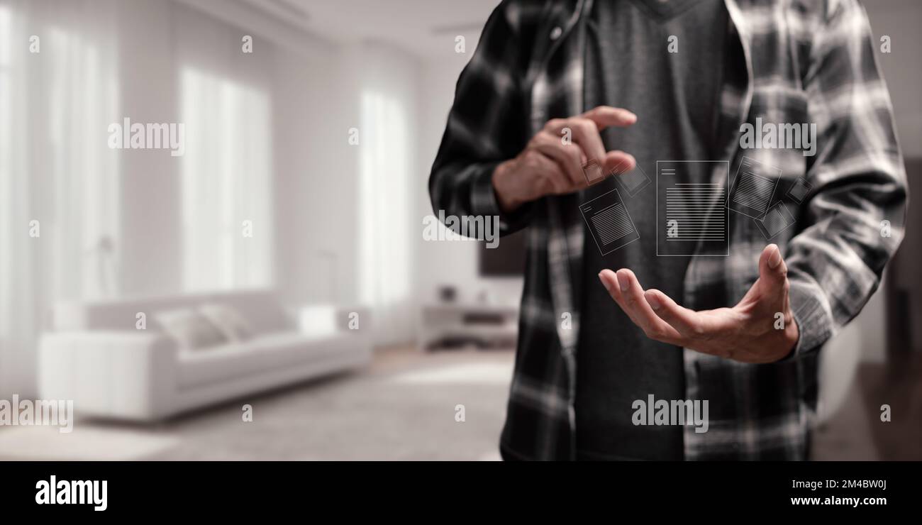 A young man holding a floating digital business document Stock Photo ...