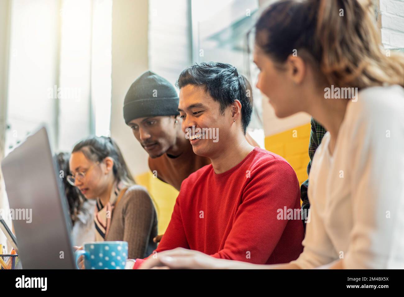 Young co-workers multiethnic team planning a new startup - Happy ...