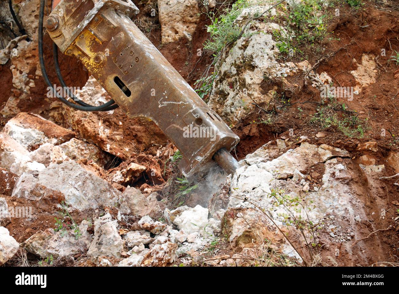 excavator crusher machine breaks rocks to widen road Stock Photo - Alamy