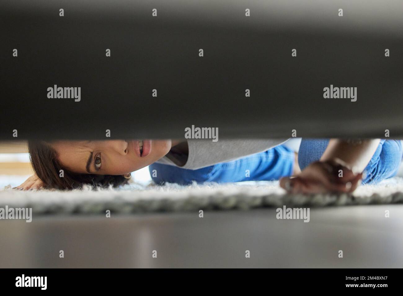 Woman, confused and couch looking for lost product in her home living ...