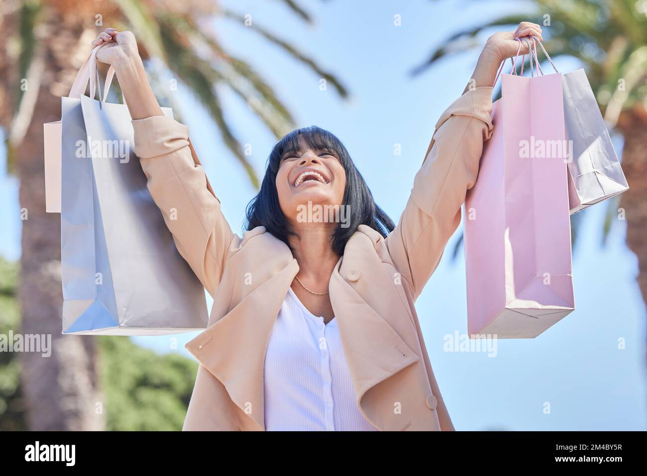 Success, shopping bag and celebration of woman in city after buying ...