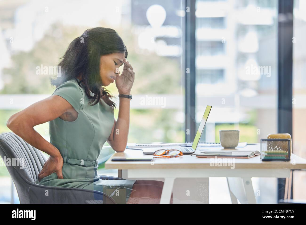 Burnout, back pain or black woman with headache in office from ...