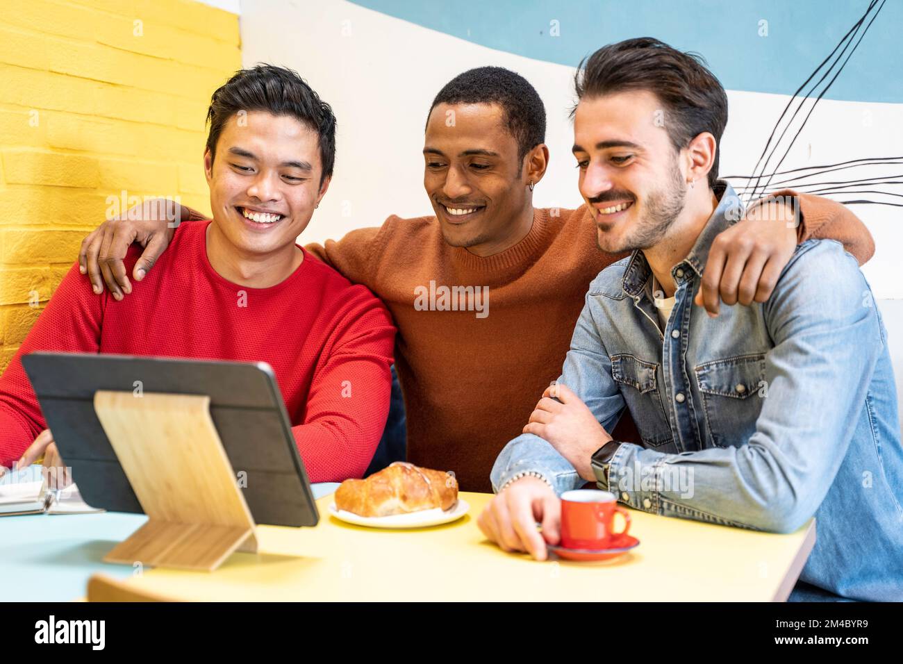 Multiethnic college students video calling friends having breakfast at ...