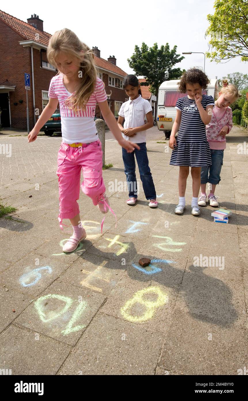 Netherlands, Young children play hopscotch in the street Stock Photo ...