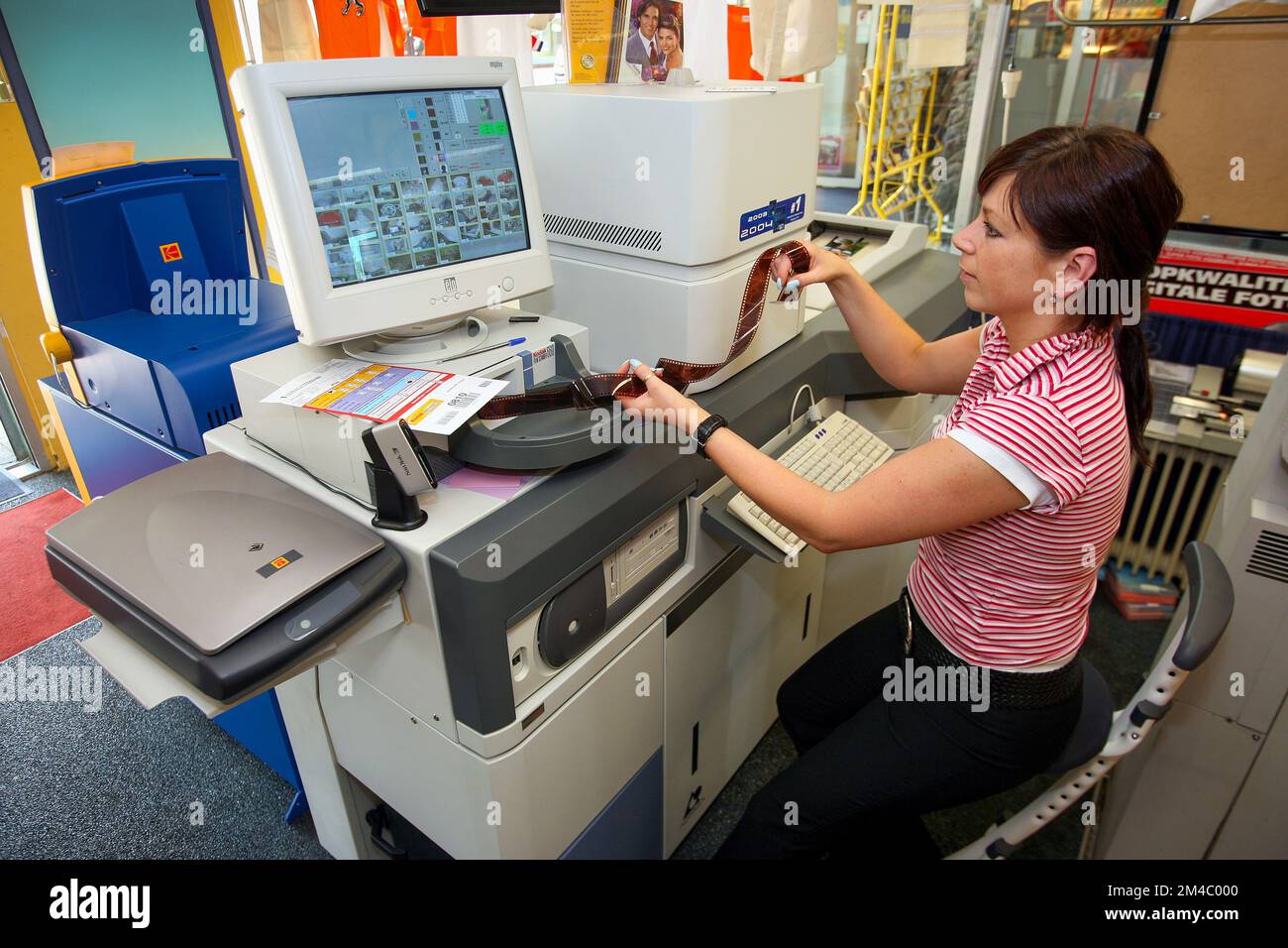 A print machine prints photos from a color negative film from an analog ...