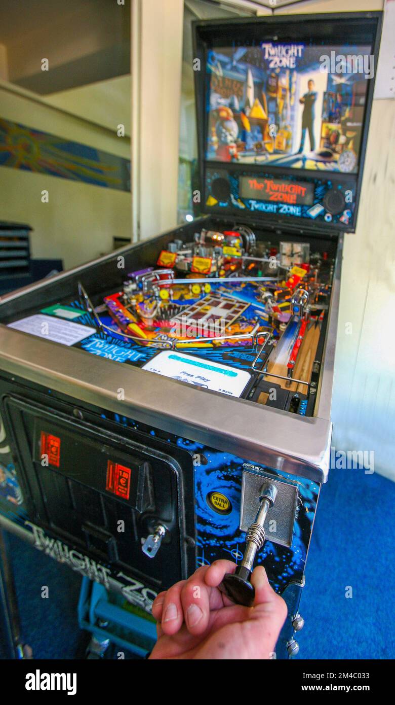 Nethrlands, player behind a pinball machine pulls out the spring to ...