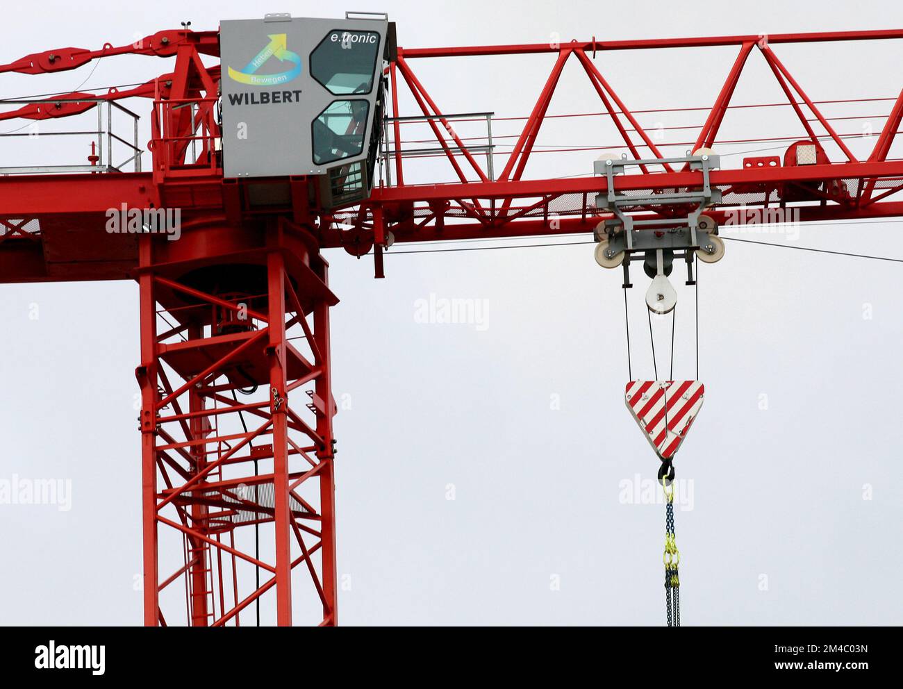 lifting crane with a pulley hoists material on a construction site ...