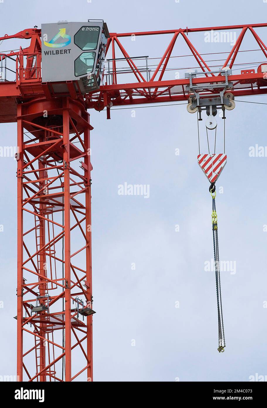 lifting crane with a pulley hoists material on a construction site ...