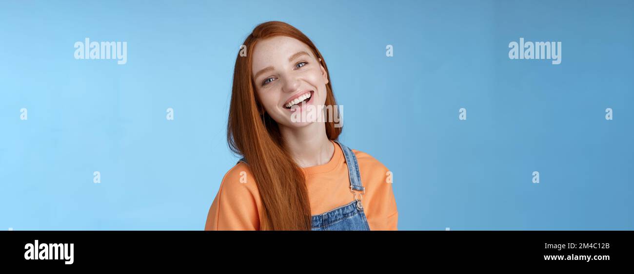 Positive outgoing lively redhead girl laughing joyfully having fun ...